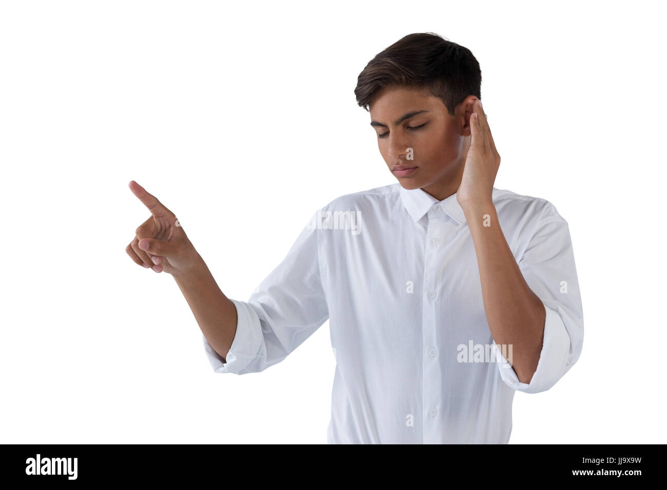 Boy pressing an invisible virtual screen against white background Stock ...