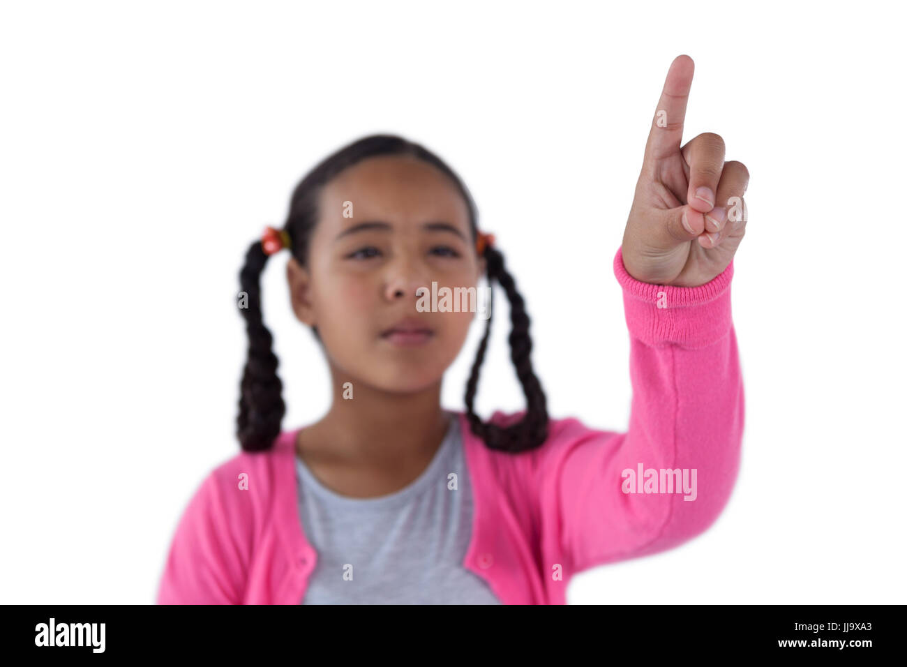 Girl pressing an invisible virtual screen against white background ...