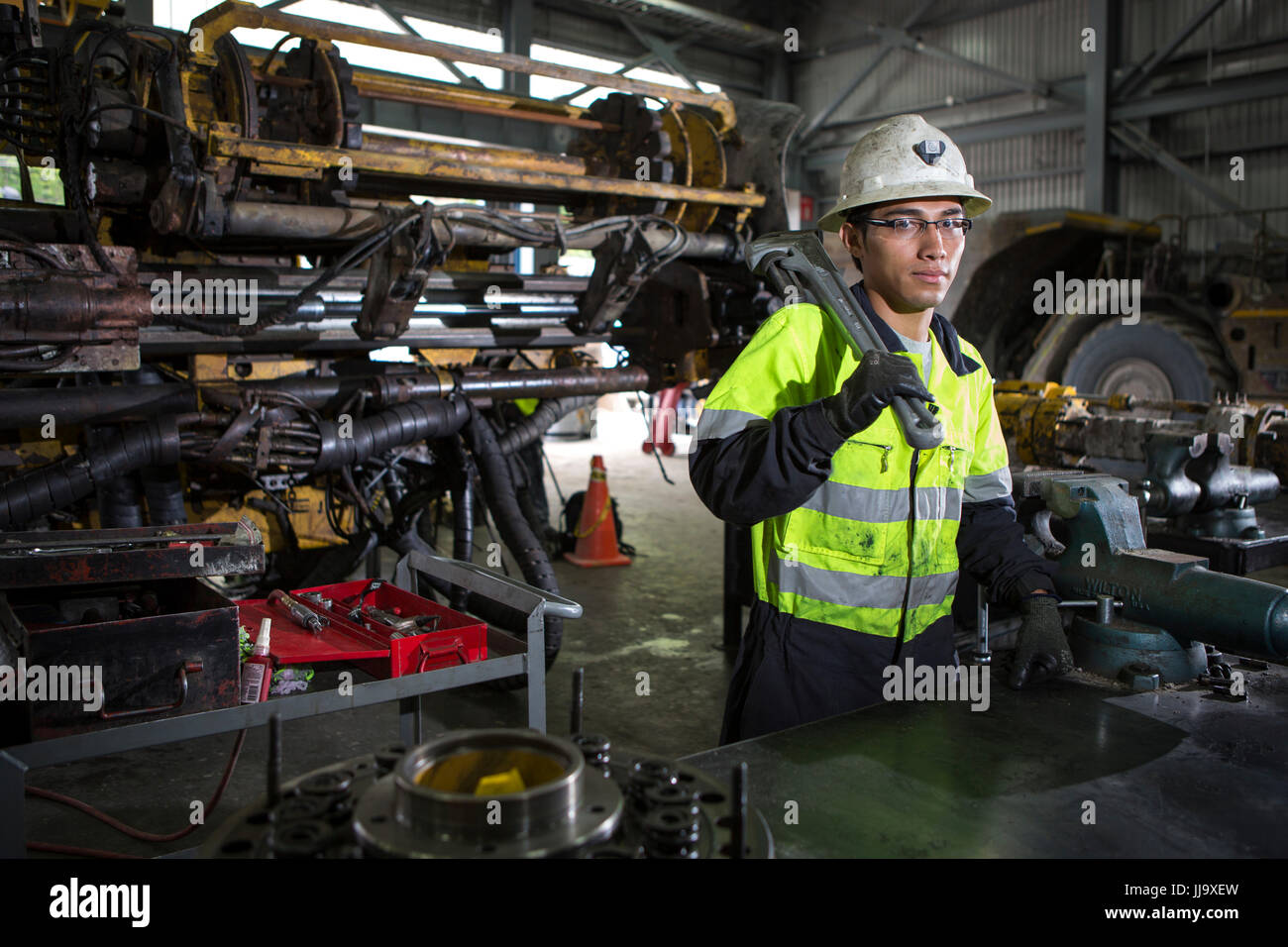 Mechanic grab a wrench to work on the heavy equipment use in mining ...