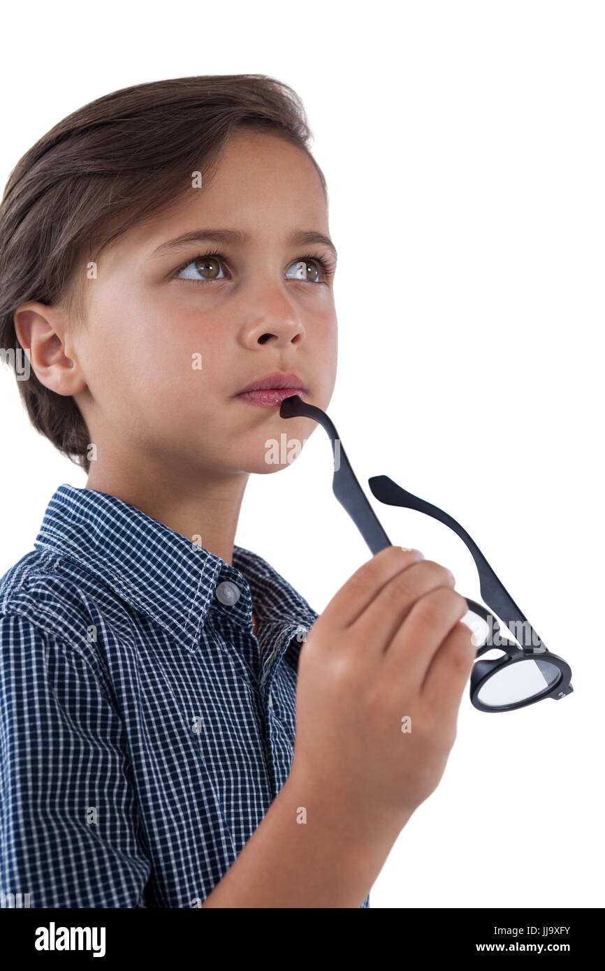 Thoughtful boy holding spectacles Stock Photo - Alamy