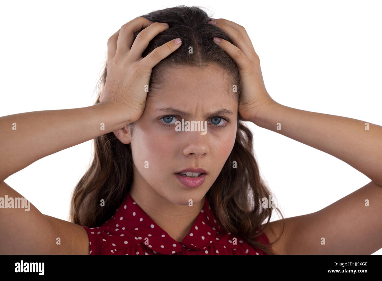 Confused teenage girl standing against white background Stock Photo - Alamy