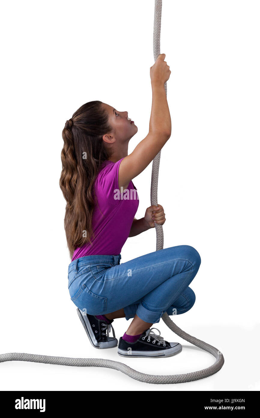 Girl climbing the rope against white background Stock Photo - Alamy