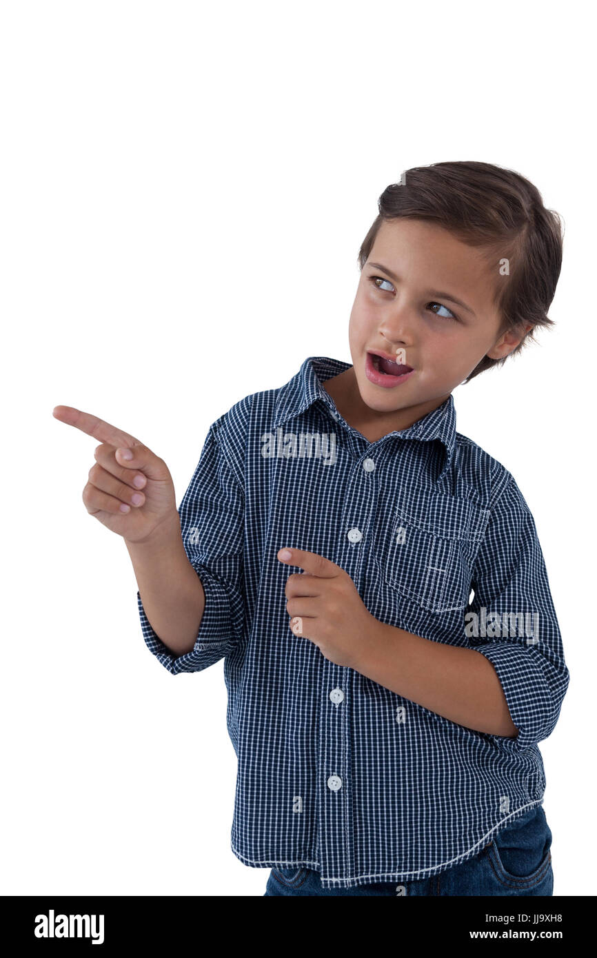 Cute boy pointing finger against white background Stock Photo - Alamy