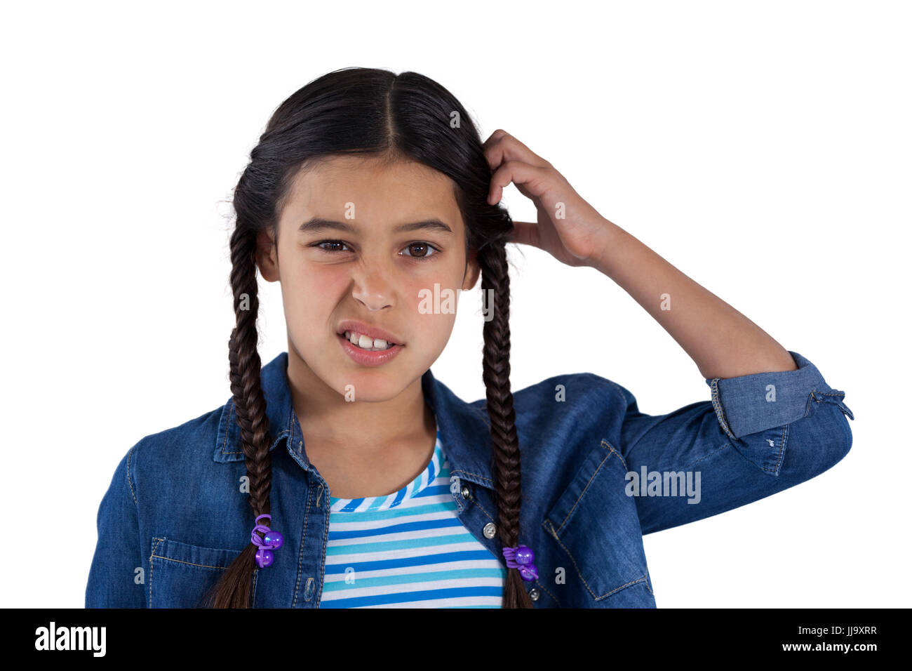 Confused teenage girl standing against white background Stock Photo - Alamy