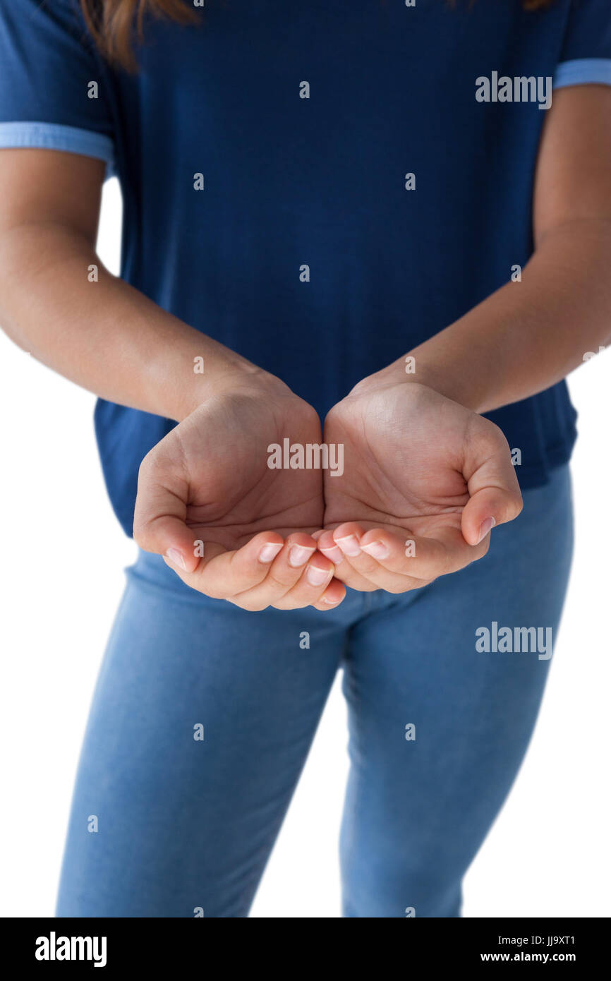 Mid-section of girl with hand cupped against white background Stock ...