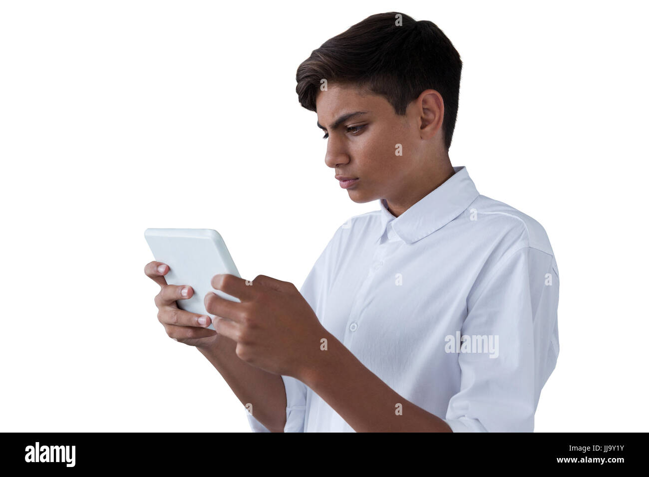 Boy using digital tablet against white background Stock Photo - Alamy