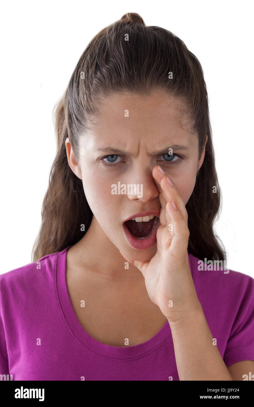 Angry girl screaming against a white background Stock Photo - Alamy