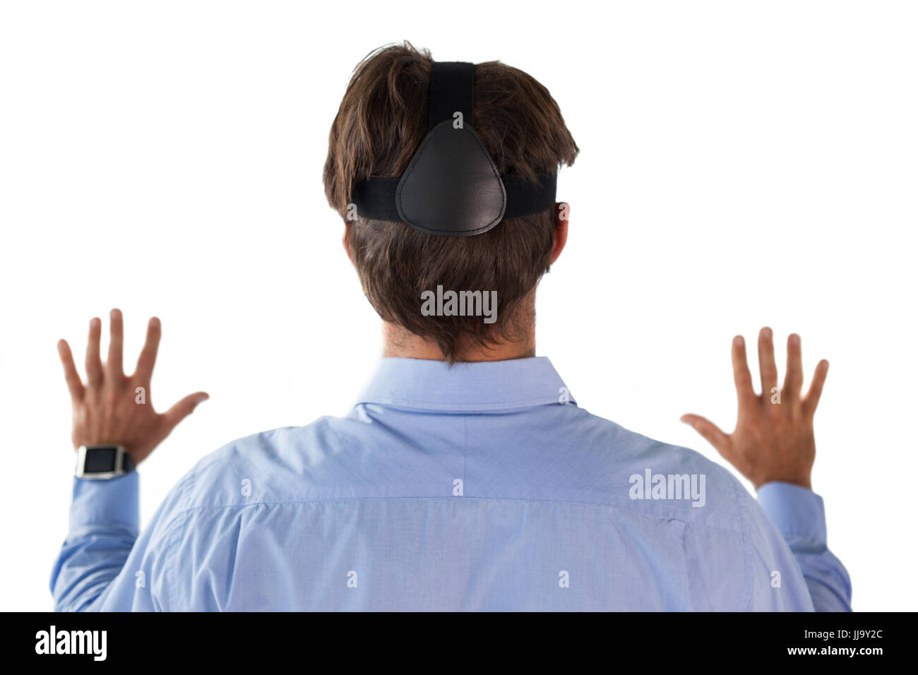 Rear view of businessman wearing vr glasses against white background ...