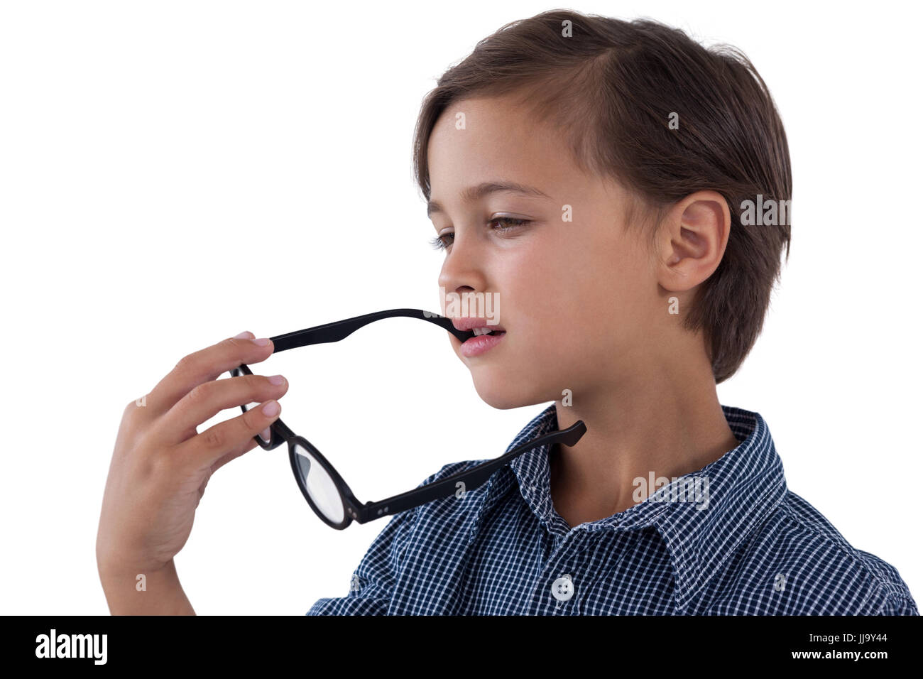 Thoughtful boy holding spectacles Stock Photo - Alamy