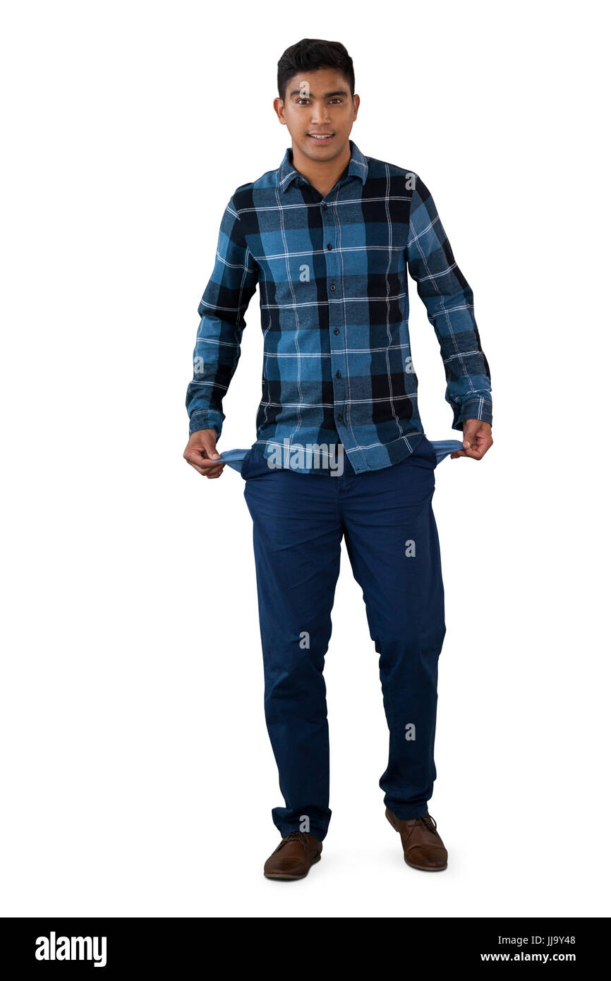 Portrait of young man showing empty pockets while standing against ...