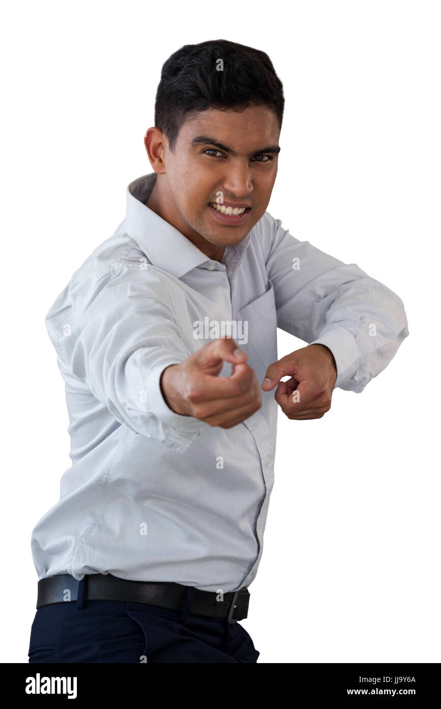 Portrait of businessman pulling invisible rope while standing against ...