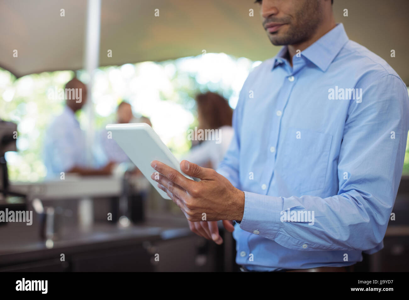 Mid-section of waiter using digital tablet at outdoor cafÃƒÂ© Stock ...