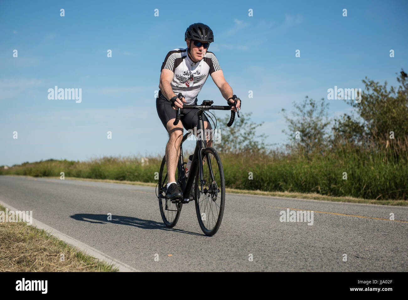 Cyclist riding on the road Stock Photo - Alamy