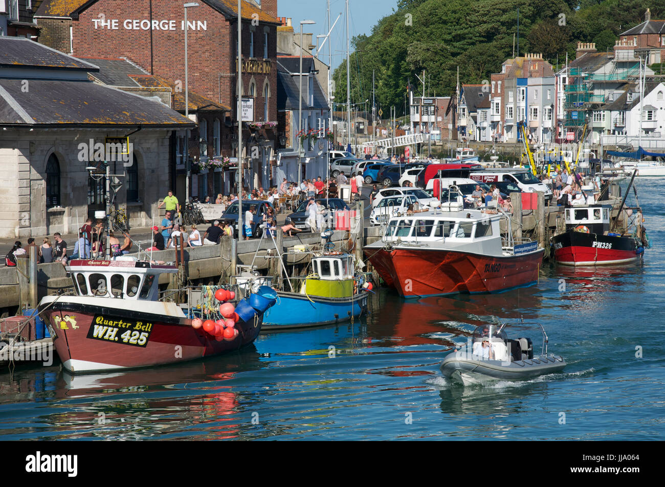 Custom House Quay in Weymouth viewed from the Town Bridge. Crowds of ...