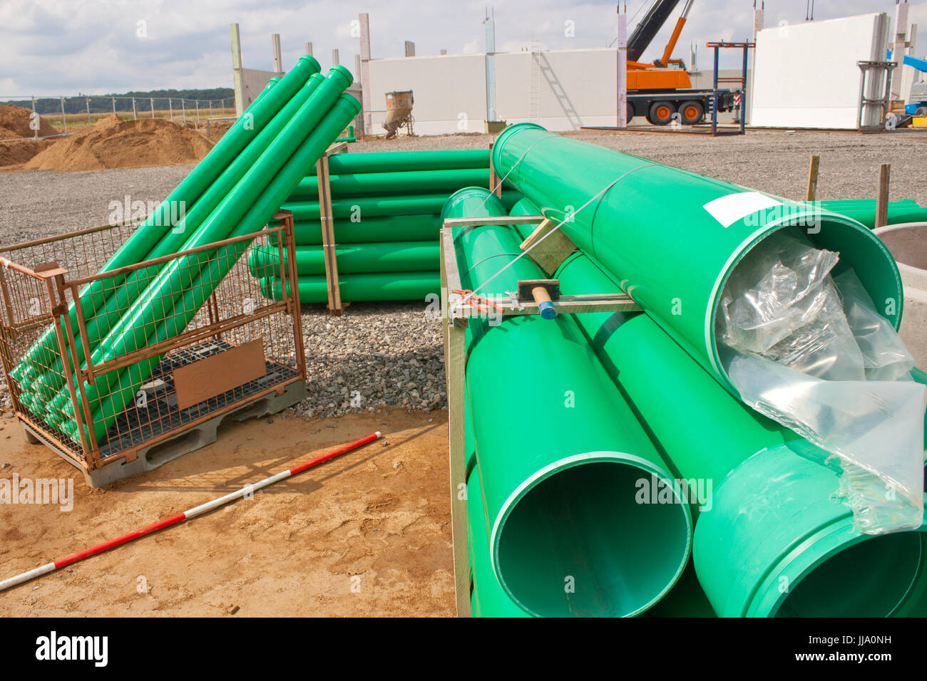 Stack of green sewer pipes on building site outdoor shot Stock Photo ...