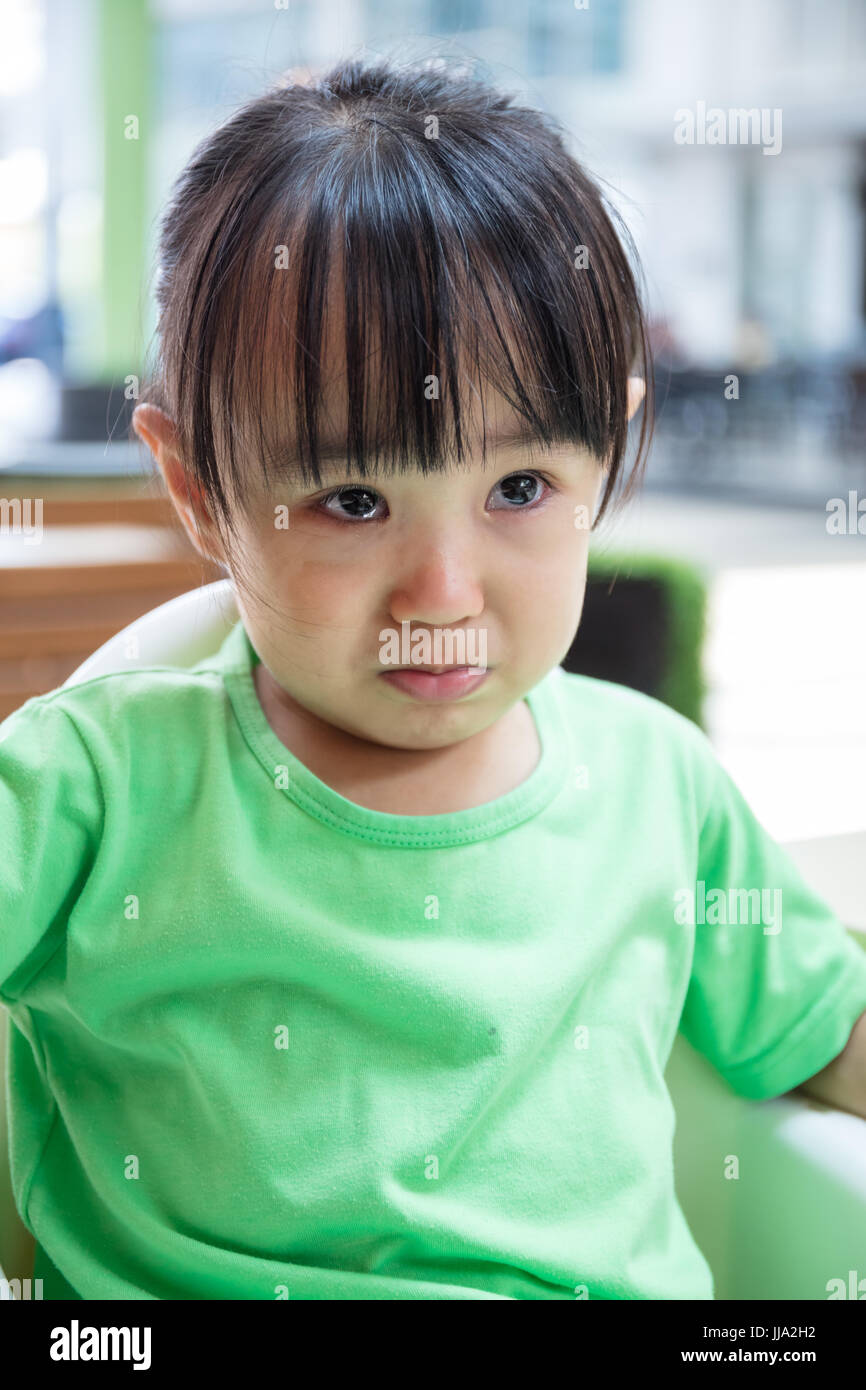 Asian Chinese little girl crying at outdoor restaurant Stock Photo - Alamy