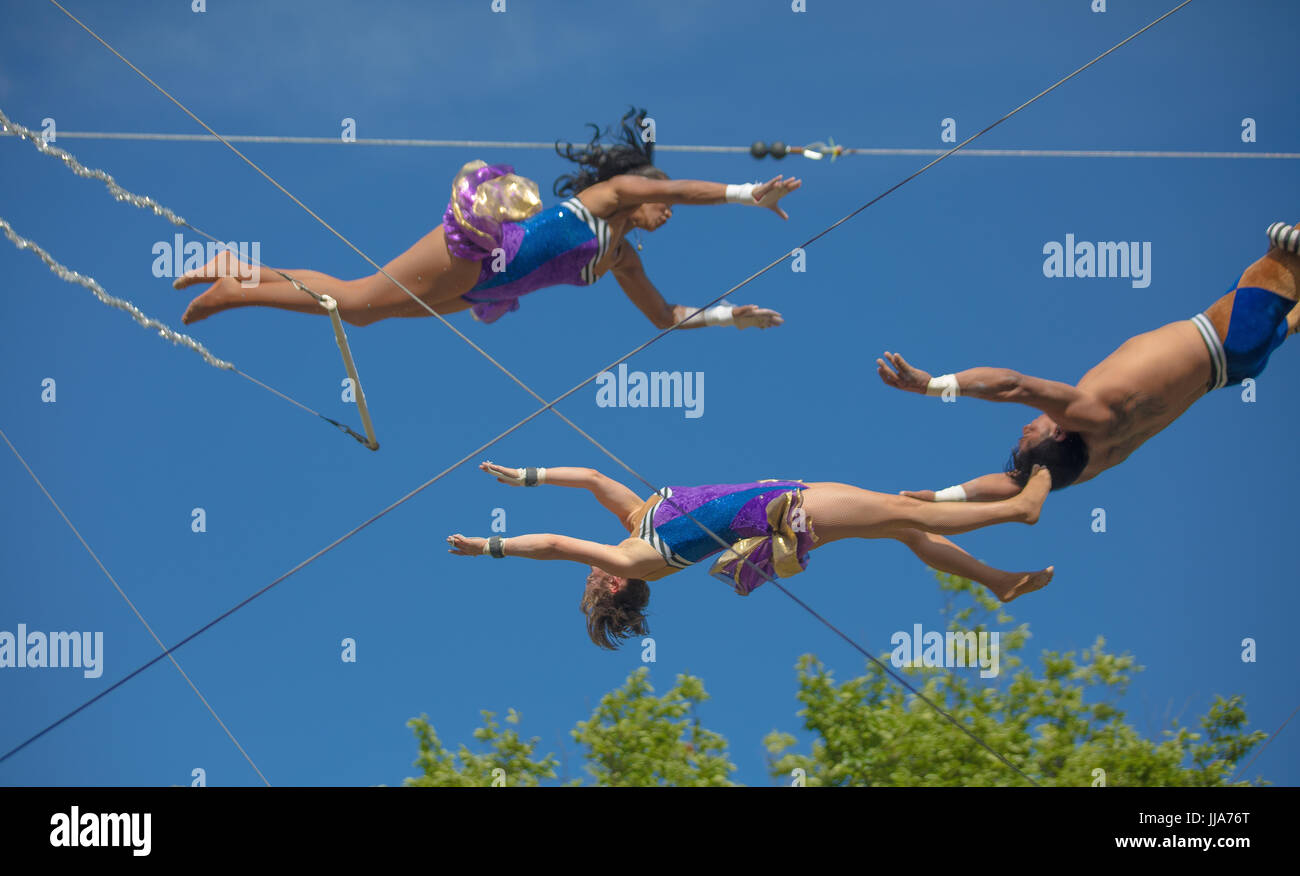 Trapeze artists Kristin Finley (top) and Sara Deull complete a passing ...