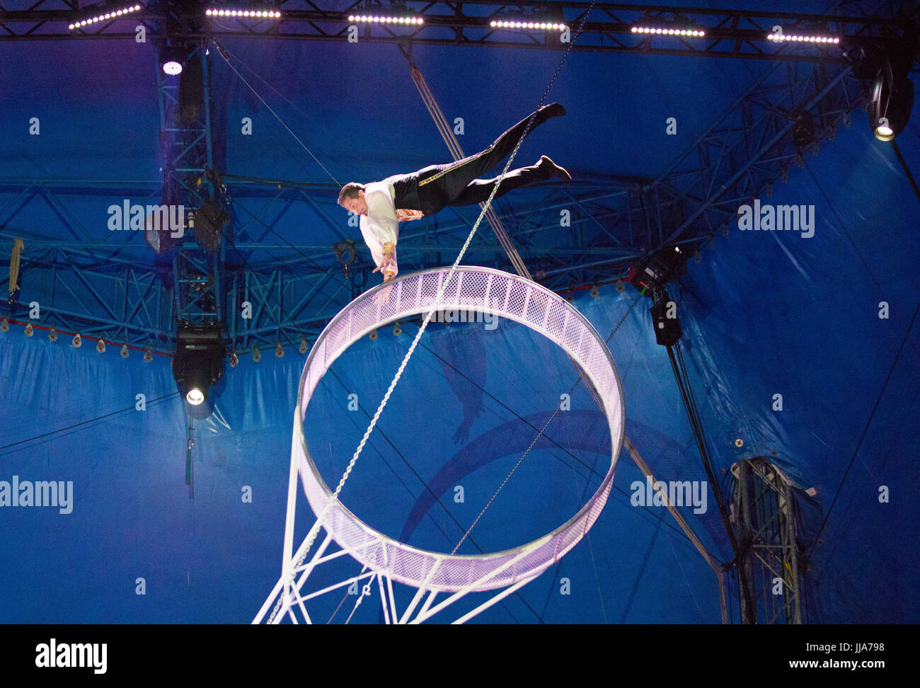 Joseph Dominic Bauer demonstrates his acrobatic skills on the "wheel of ...