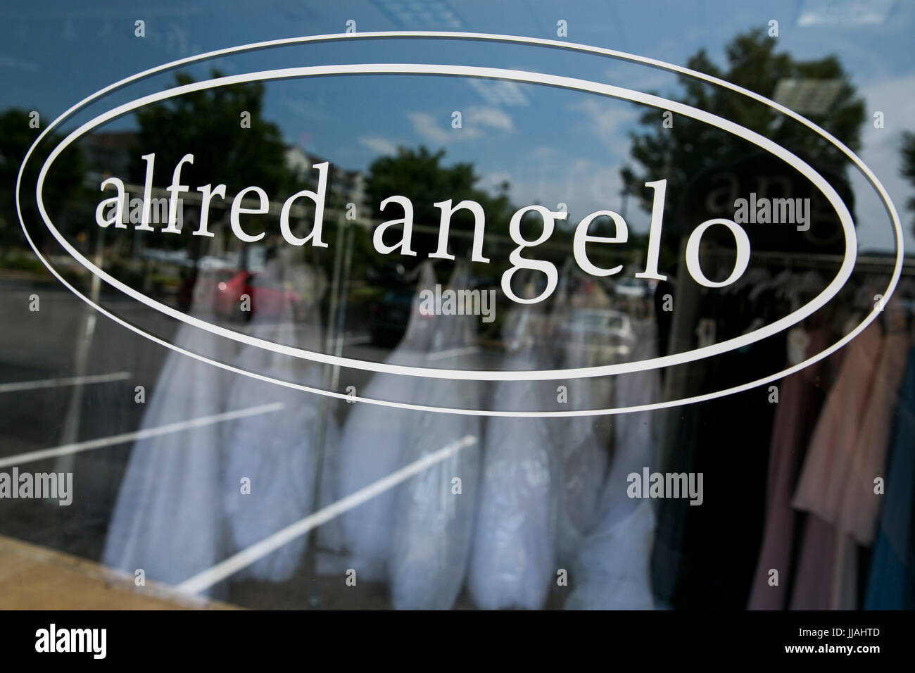 A "Store Closed" sign outside of a Alfred Angelo Bridal retail store ...