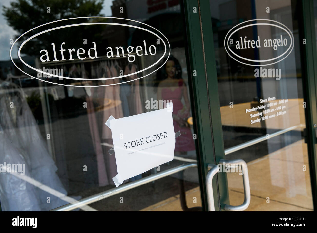 A "Store Closed" sign outside of a Alfred Angelo Bridal retail store ...