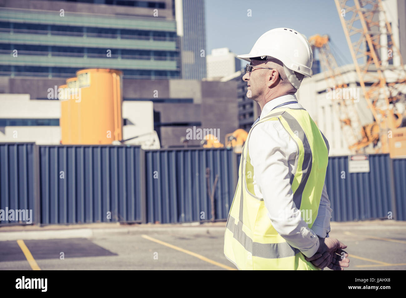 Senior foreman in glasses doing his job at building area on sunn Stock ...