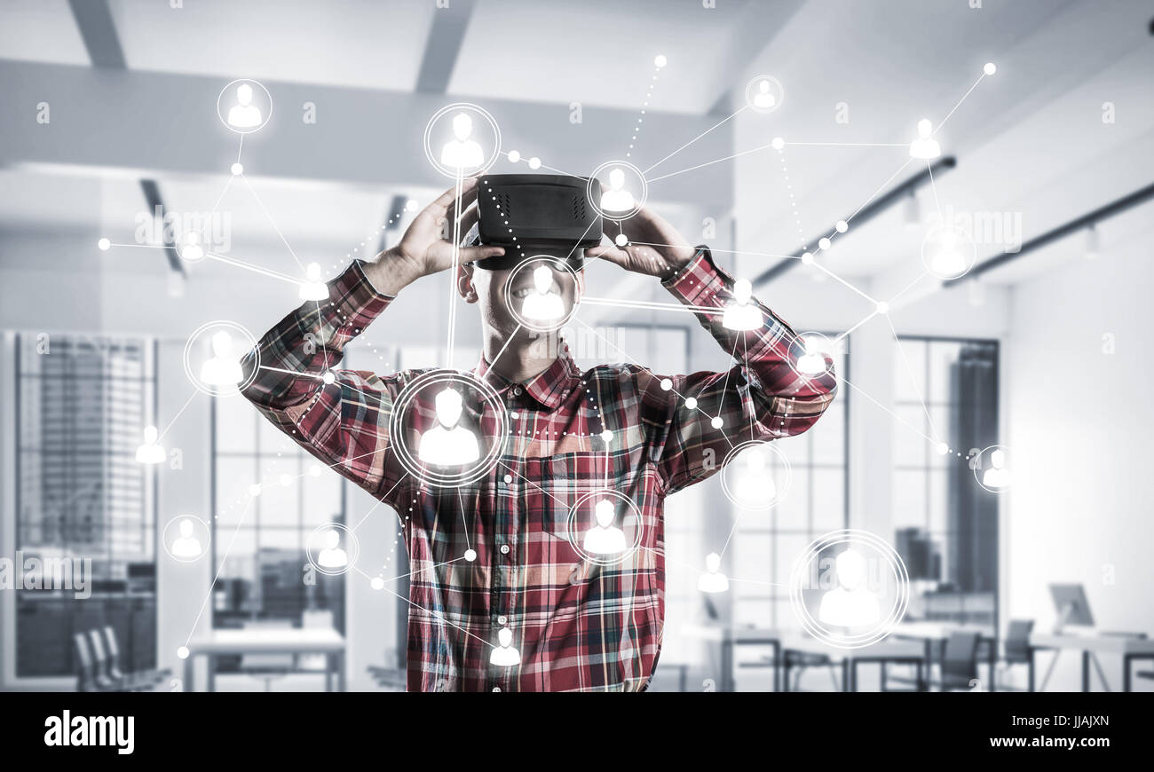 Guy wearing checked shirt and virtual mask demonstrating some em Stock ...