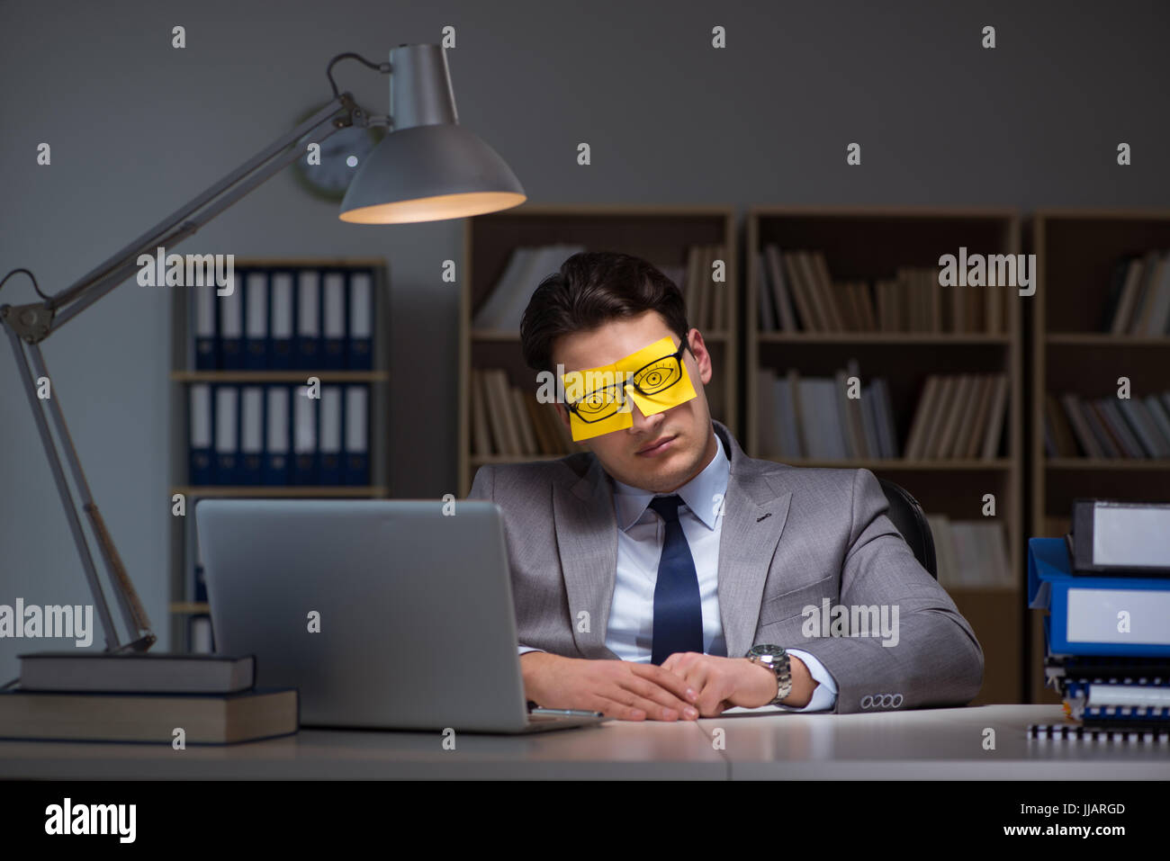 Businessman staying late to sort out priorities Stock Photo - Alamy