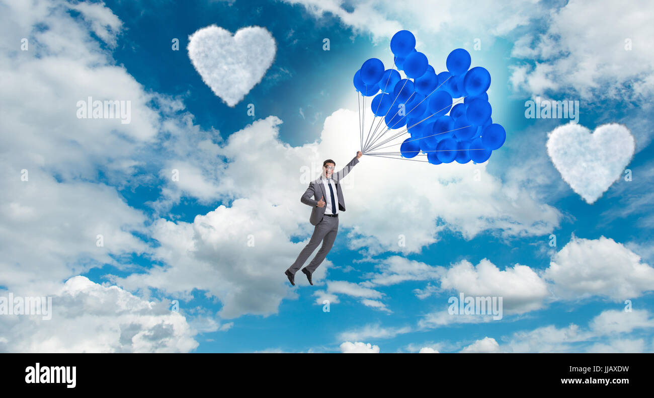Man flying balloons in romantic concept Stock Photo - Alamy