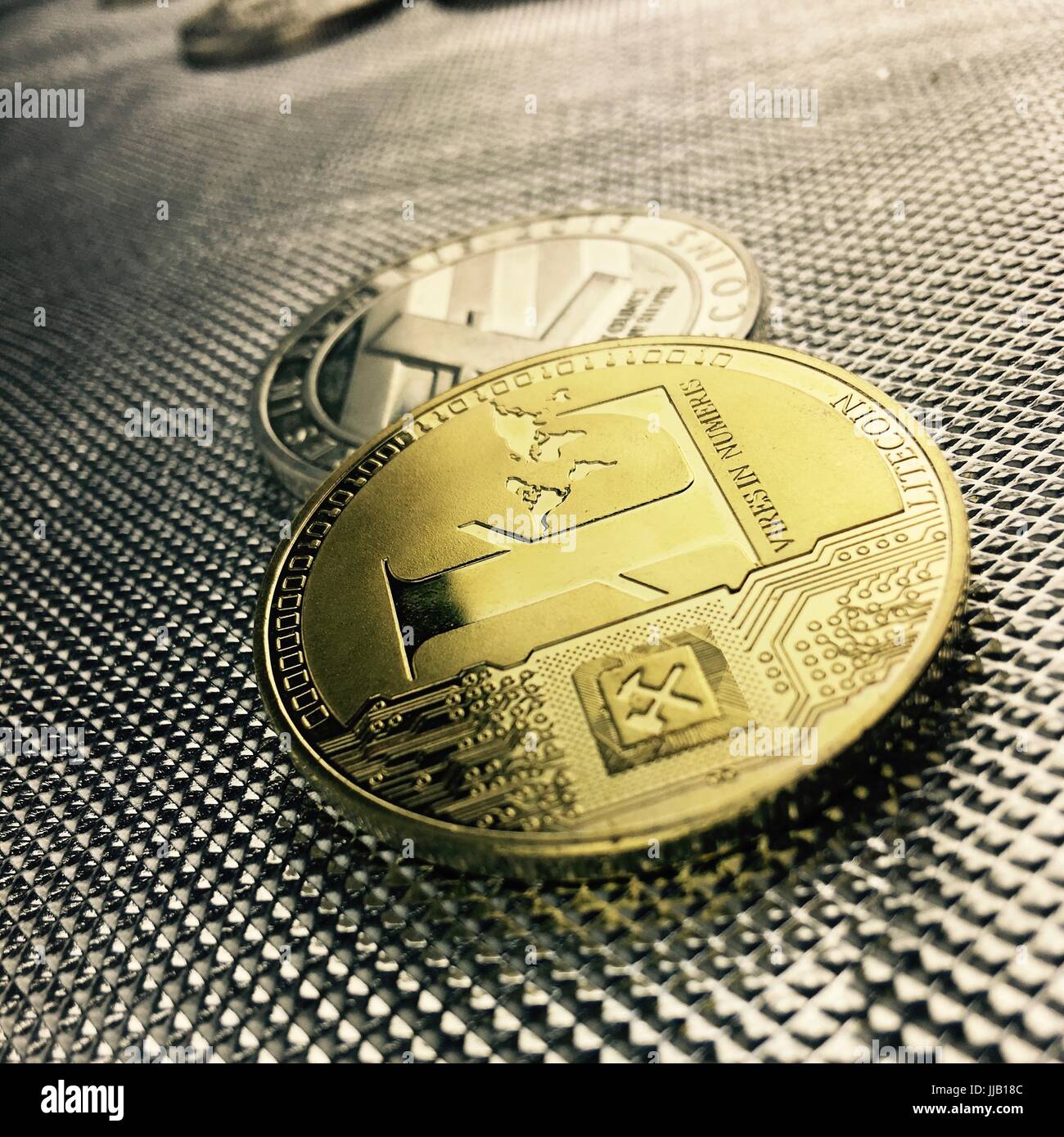 Digital currency physical gold and silver Litecoin coin on silver ...