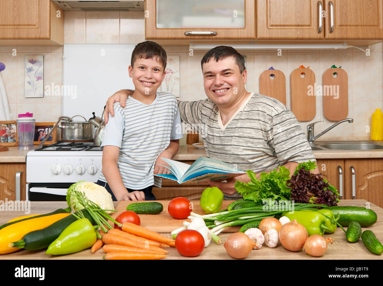 Father and child reading cooking book and choice dishes. Happy family ...