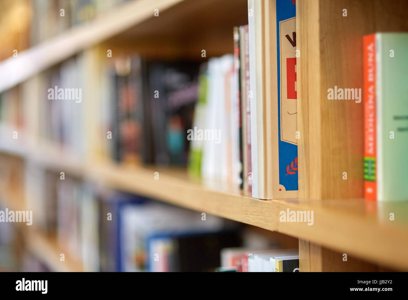Books on shelves in a public library with selective focus Stock Photo ...