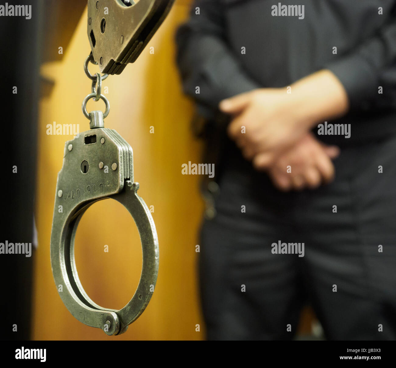 Handcuffs and lattice cells for prisoners Stock Photo - Alamy