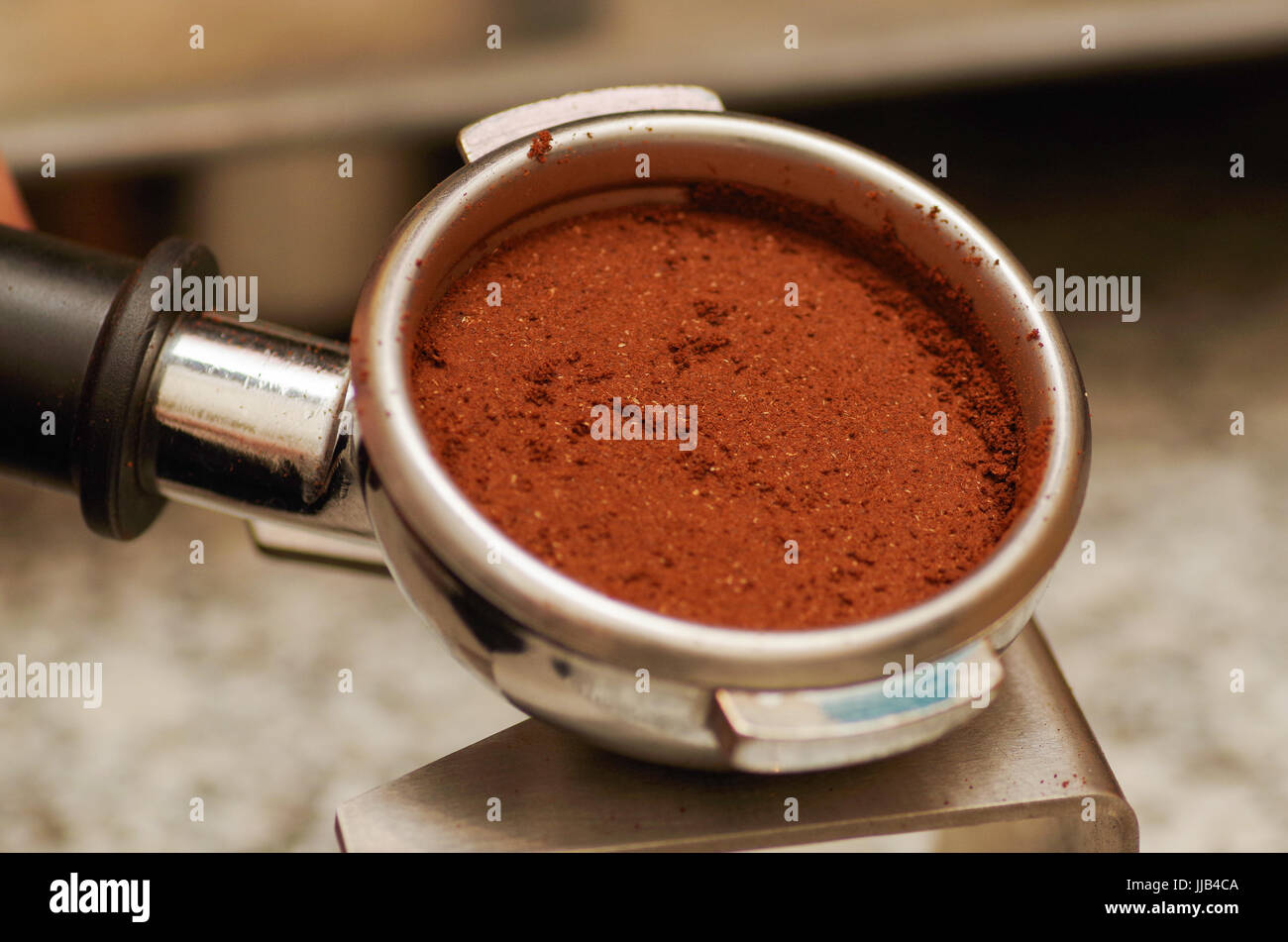 Close up of chocolate powder with cinnamon in a coffee strainer, in a ...