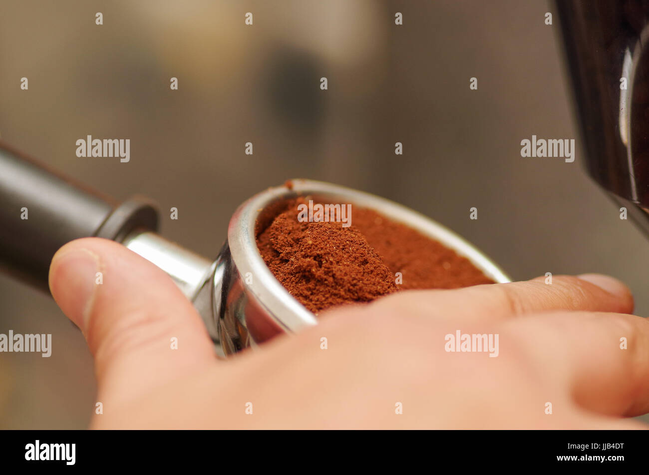 Close up of chocolate powder with cinnamon in a coffee strainer, in a ...
