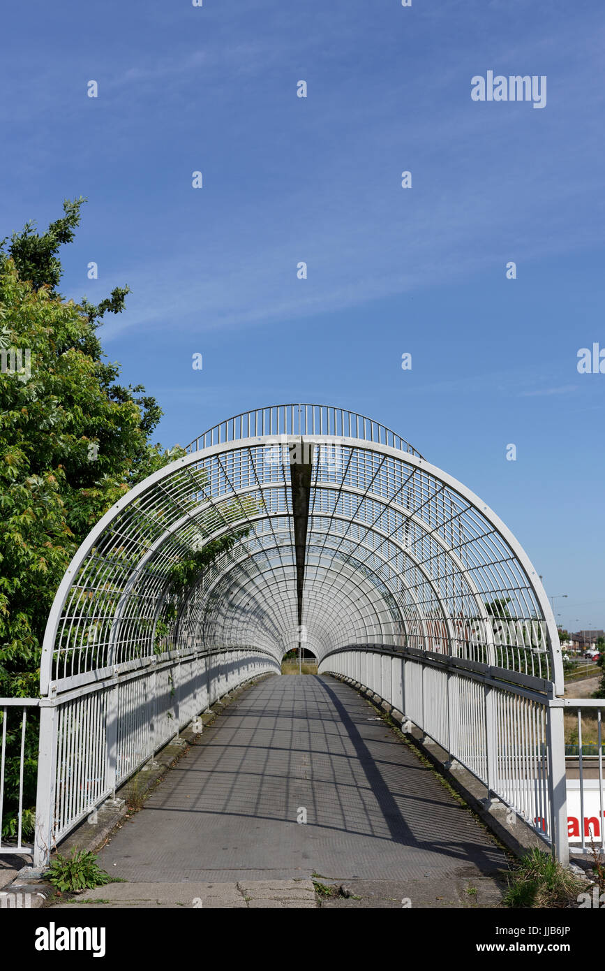 Enclosed pedestrian footbridge with steel safety cage, over m60 ...