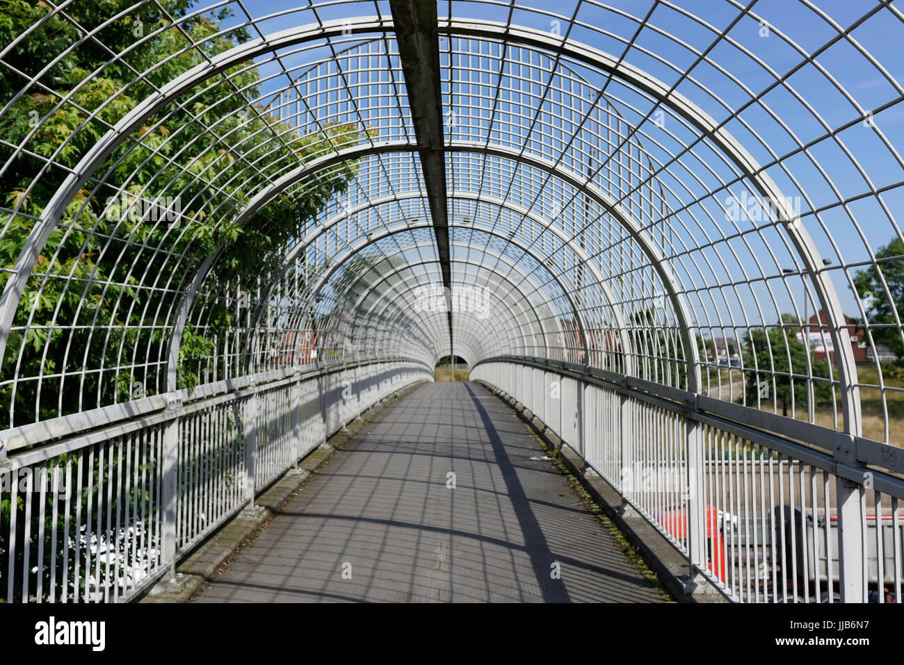 Enclosed pedestrian footbridge with steel safety cage, over m60 ...