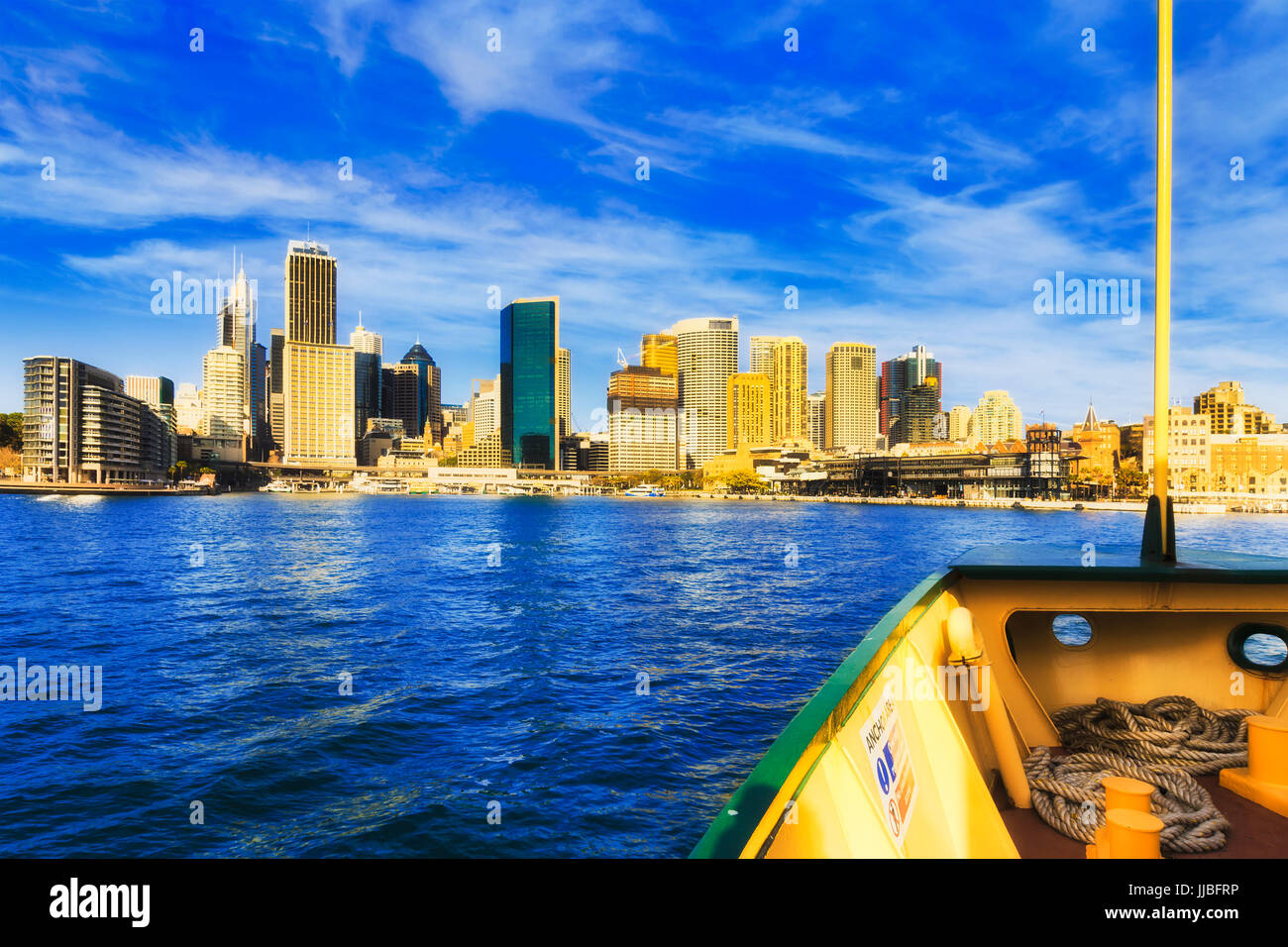 Aboard Sydney Ferry approaching Circular Quay wharfs under city CBD ...