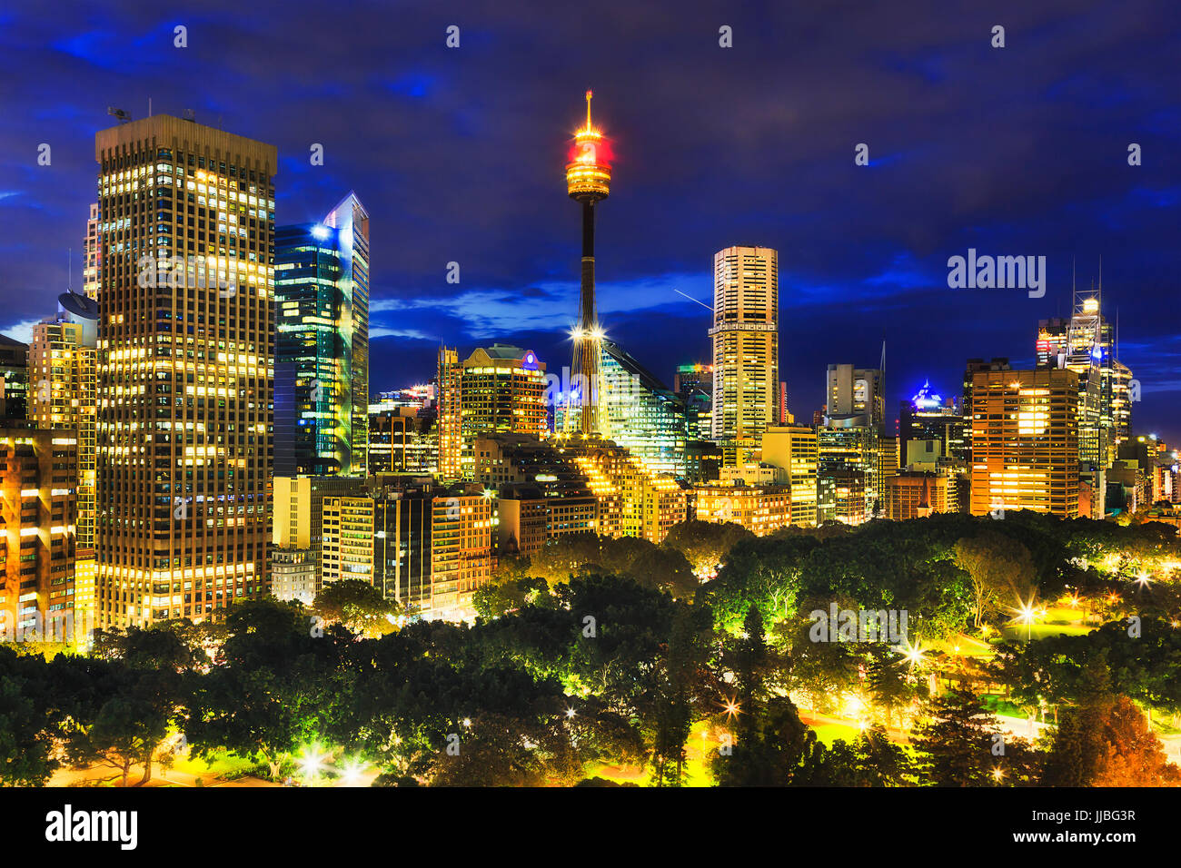 Panorama of Sydney city high-rise towers illuminated at sunset standing ...