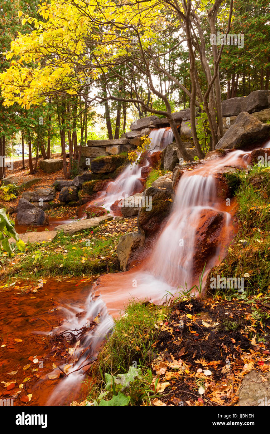 A small possibly polluted waterfall at Andrew Haydon Park during autumn ...