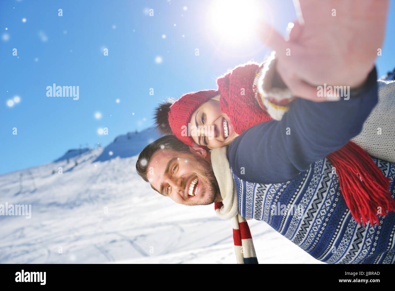 Loving couple playing together in snow outdoor Stock Photo - Alamy