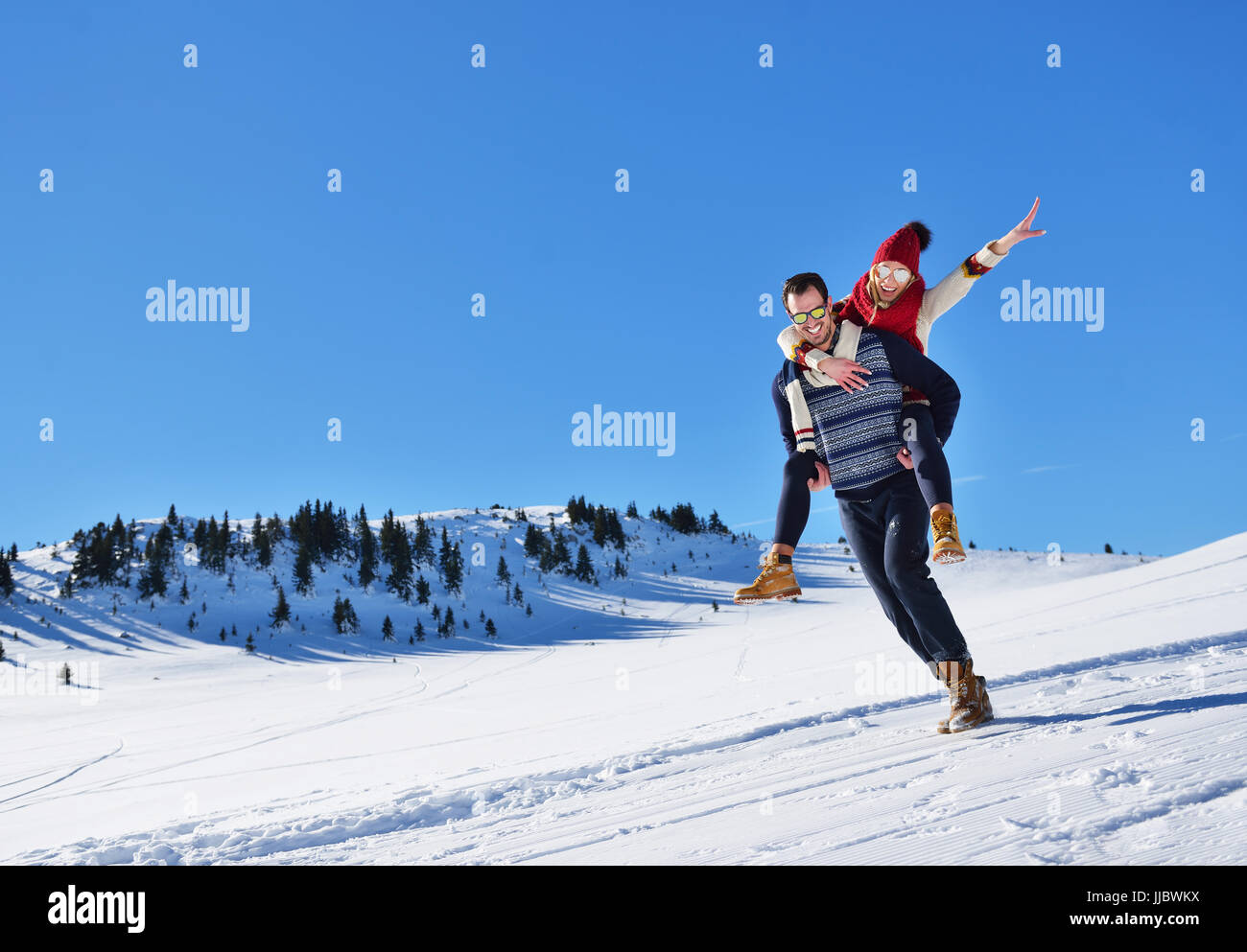 Loving couple playing together in snow outdoor Stock Photo - Alamy