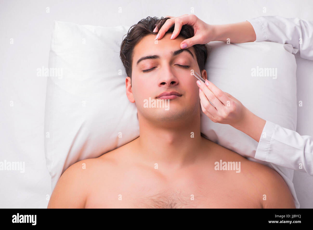 Handsome man in spa massage concept Stock Photo - Alamy