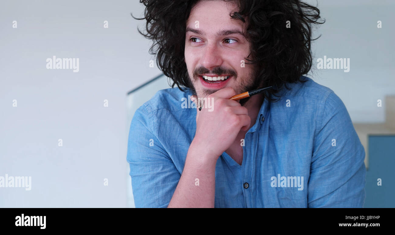 Portrait of a young handsome man enjoying free time in his luxury home ...
