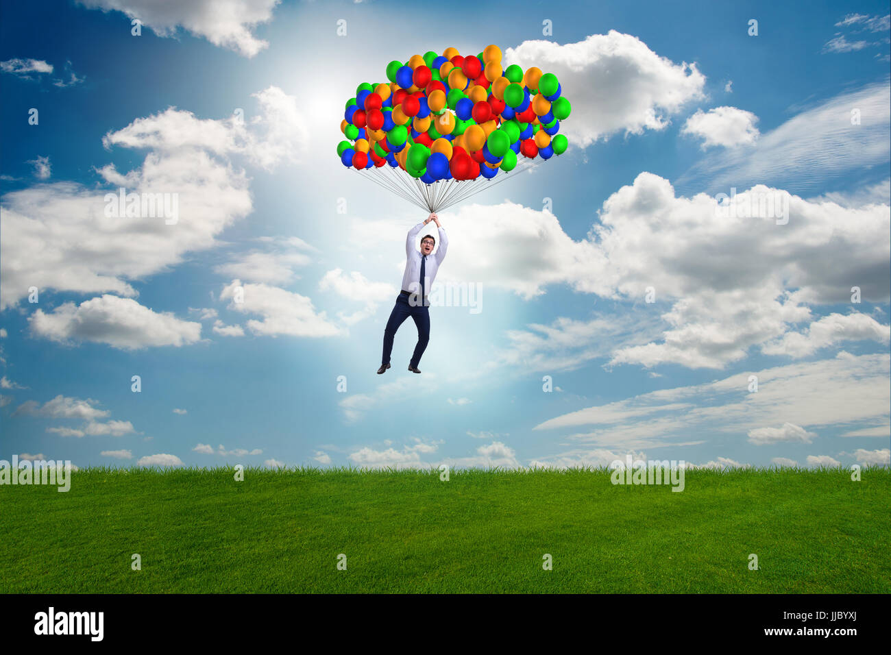Businessman flying balloons on bright day Stock Photo - Alamy