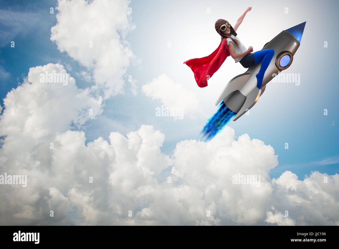 Little girl flying rocket in superhero concept Stock Photo - Alamy