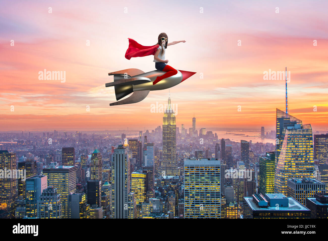 Little girl flying rocket in superhero concept Stock Photo - Alamy