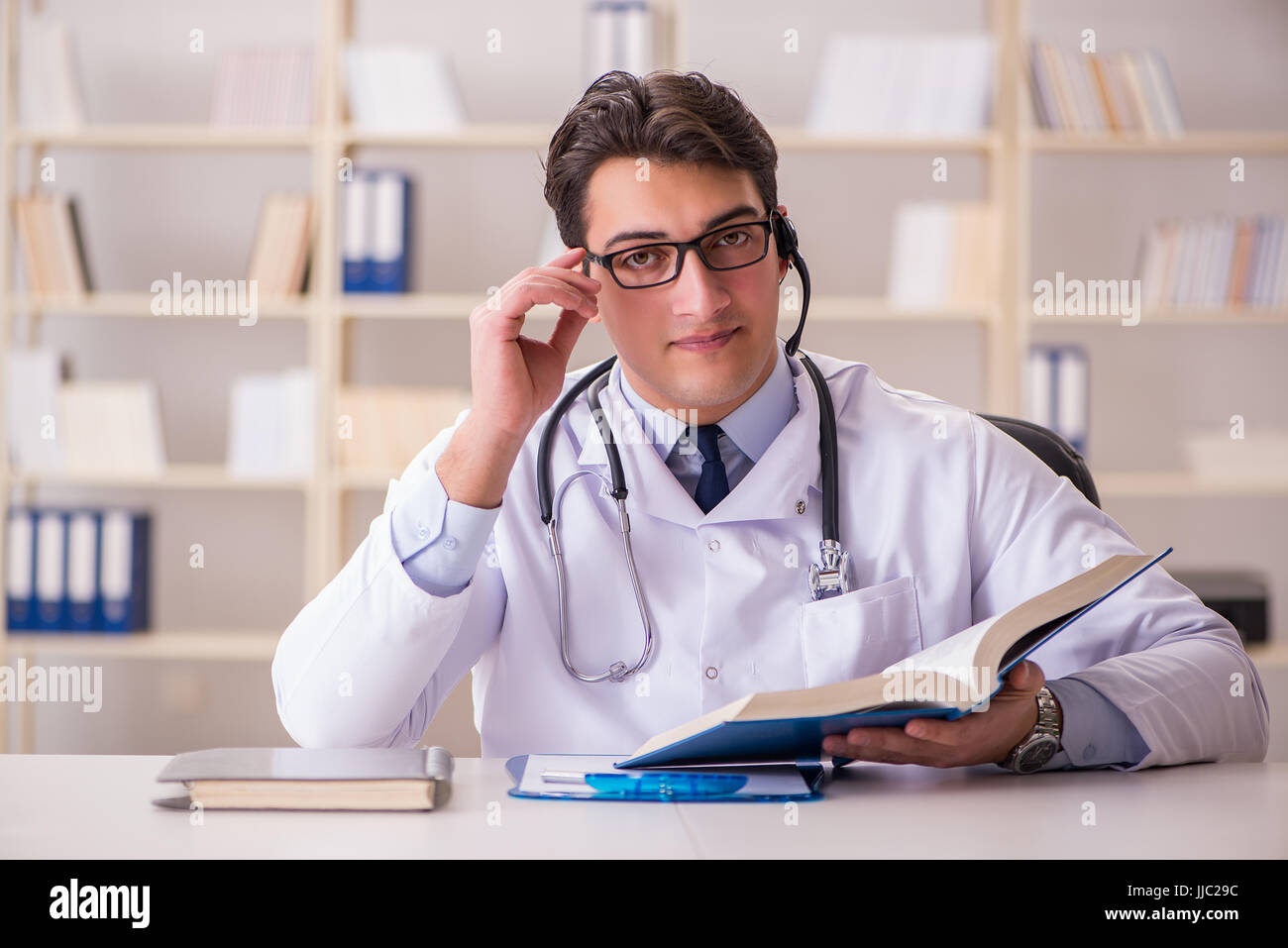 Young man doctor in medical concept Stock Photo - Alamy