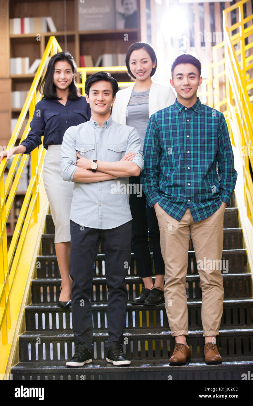 Four people standing arms hi-res stock photography and images - Alamy