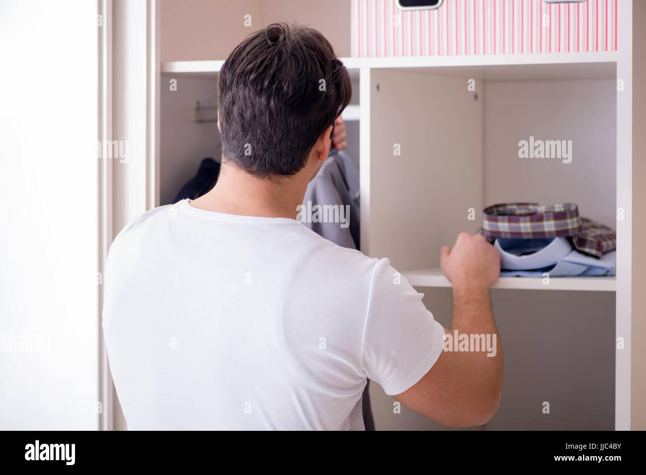 Young man businessman getting dressed for work Stock Photo - Alamy
