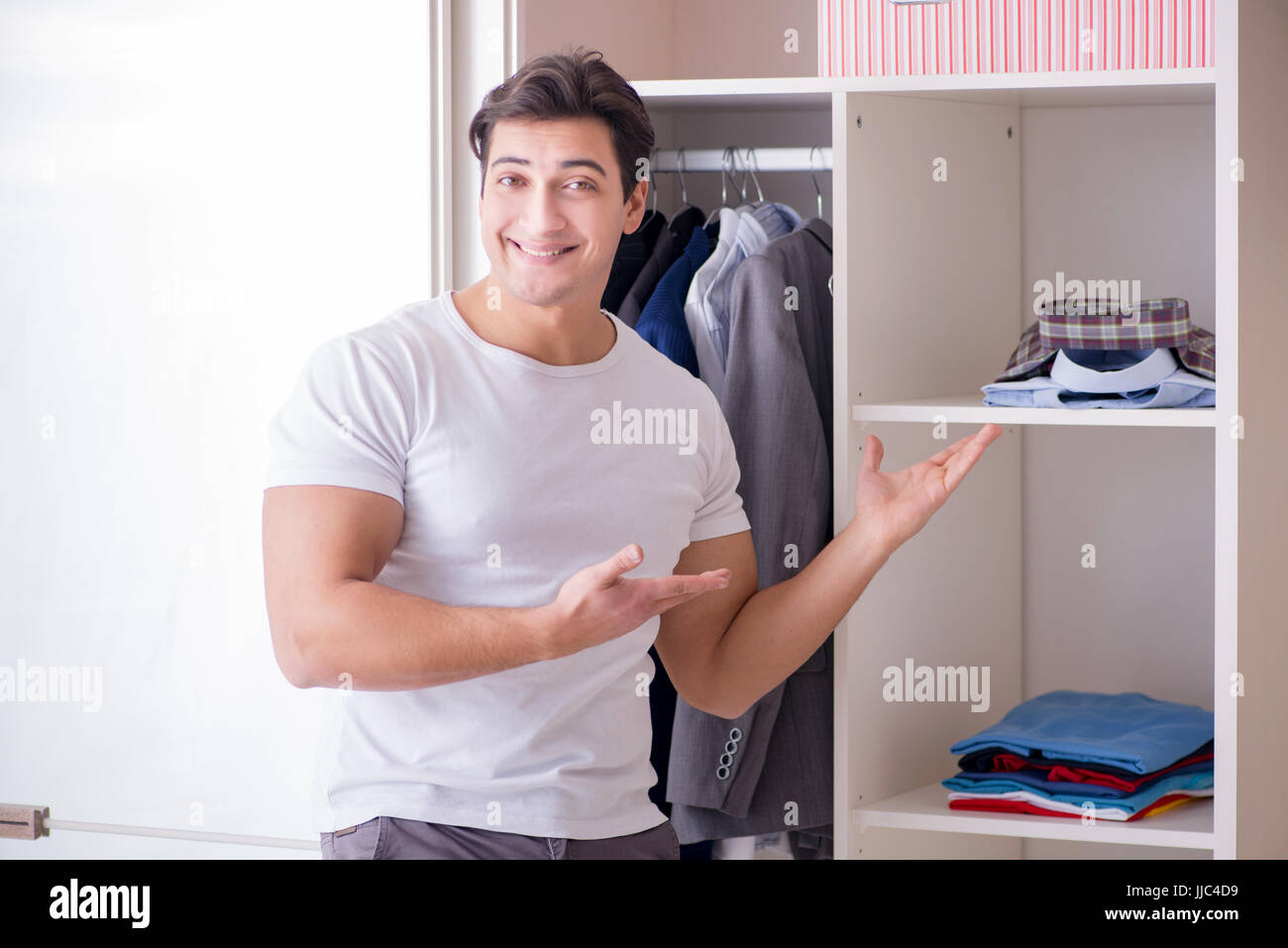 Young man businessman getting dressed for work Stock Photo - Alamy
